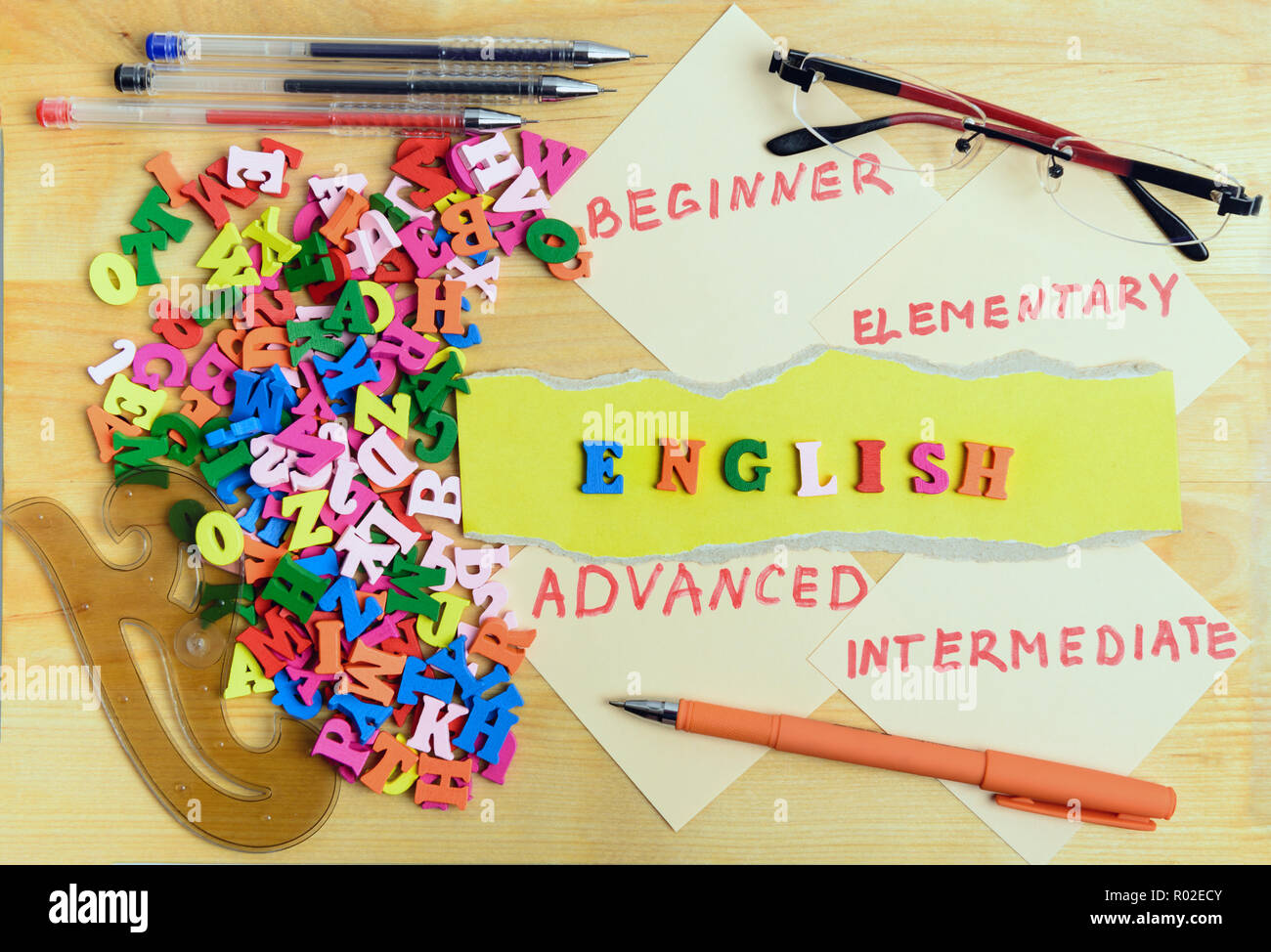 ENGLISH word in wooden letters and learning stuff near a pile of other ...