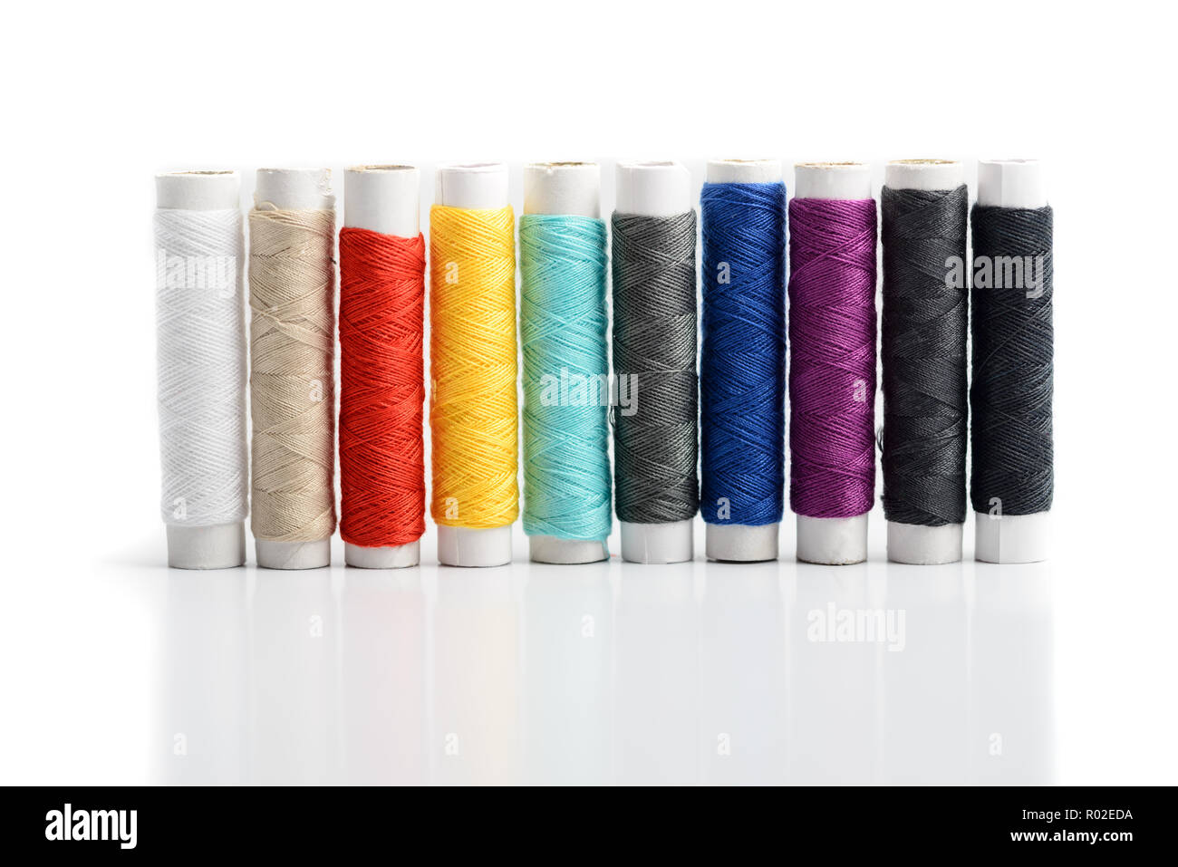Row set of color sewing threads isolated Stock Photo - Alamy