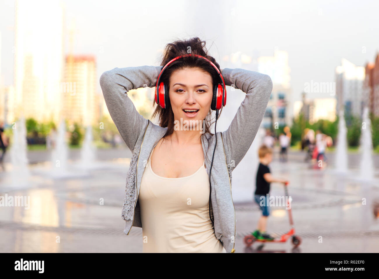 Girl listening to music streaming with headphones Stock Photo - Alamy
