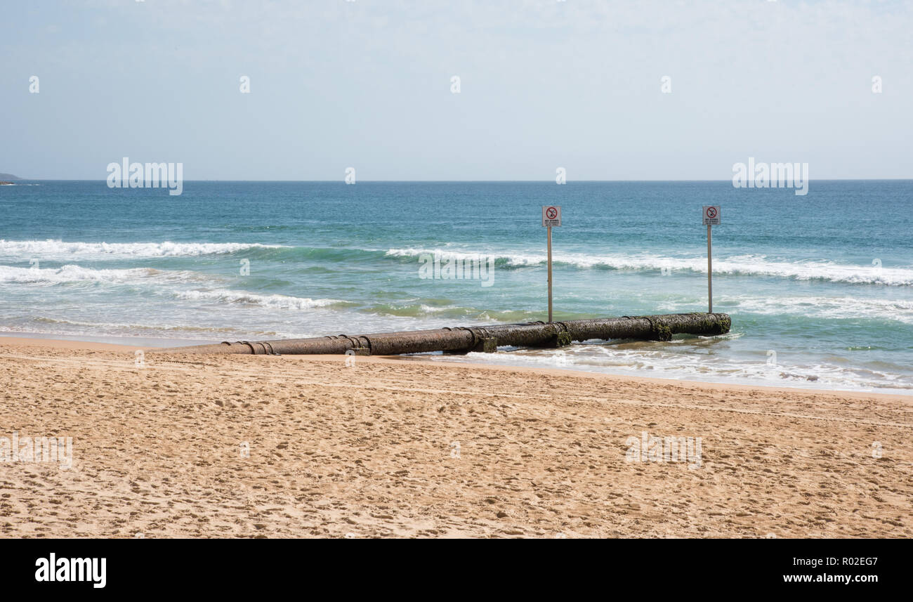 Peaceful Pacific Ocean seascape with stormwater pipes at Manly Beach in ...