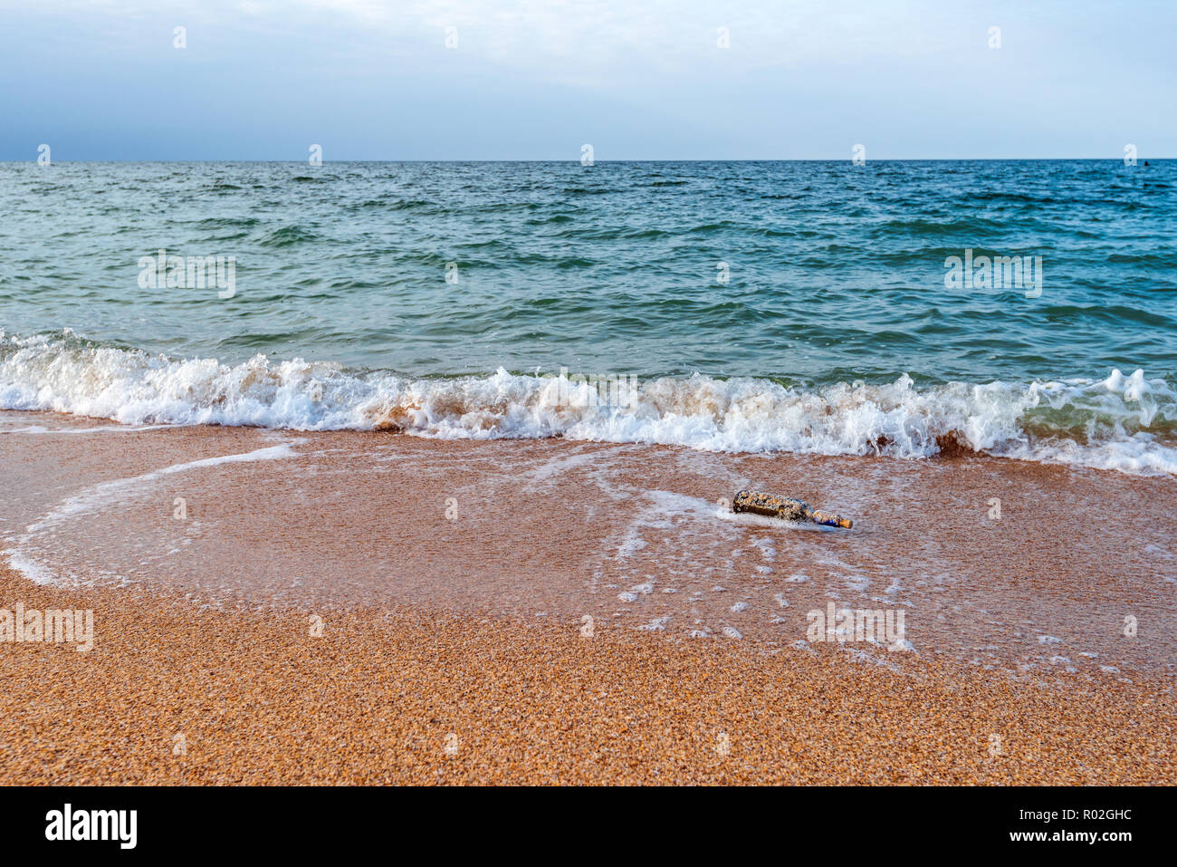 Bottle with cork on the seashore Stock Photo - Alamy