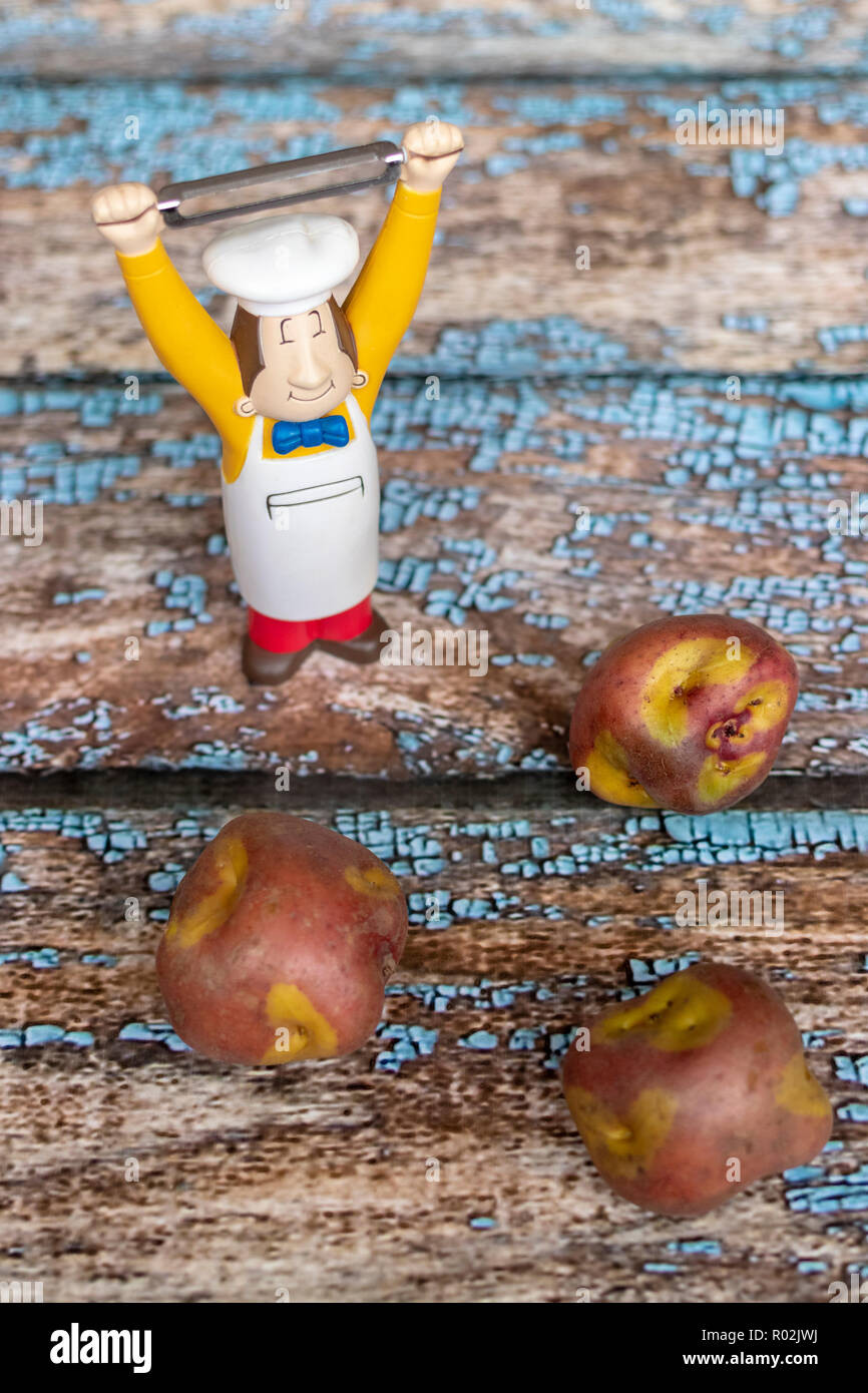 Peruvian yellow potato with potato peeler Stock Photo - Alamy