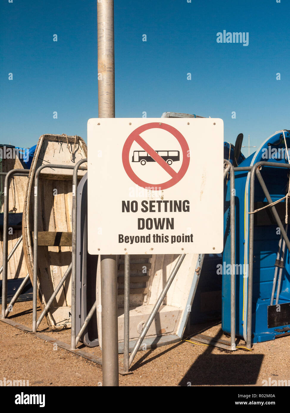 white no setting down beyond this point bus sign marina boats parked ...