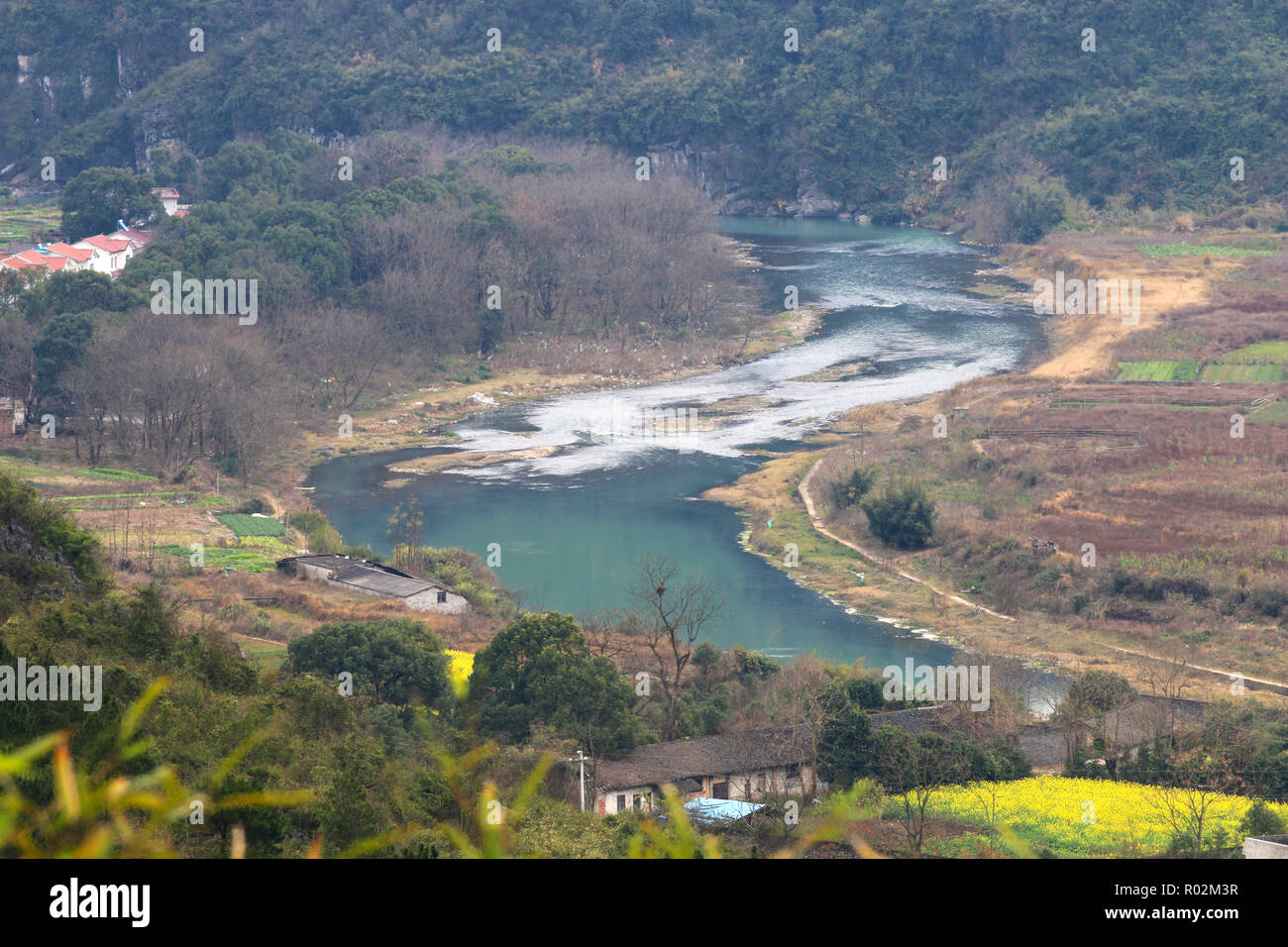 A small river that flows through a valley Stock Photo - Alamy