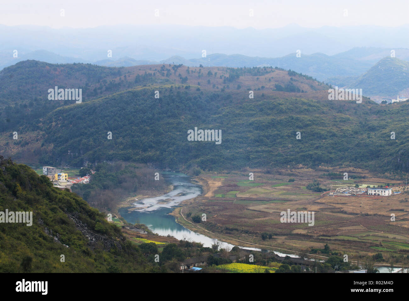 A small river that flows through a valley Stock Photo - Alamy