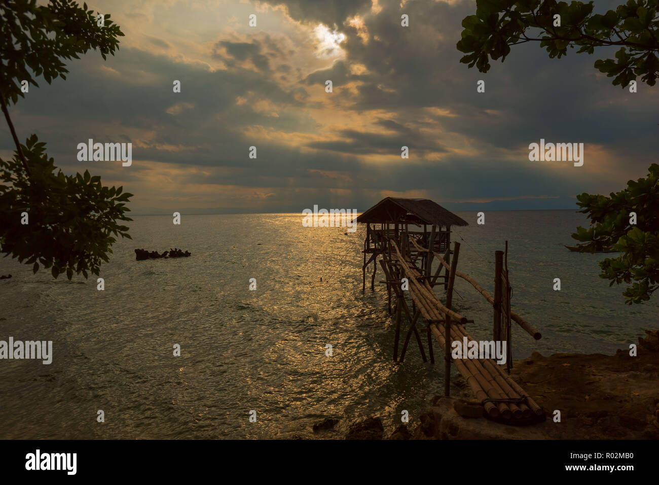 Philippine pile dwelling in a dramatic sky over tanon strait on rural ...