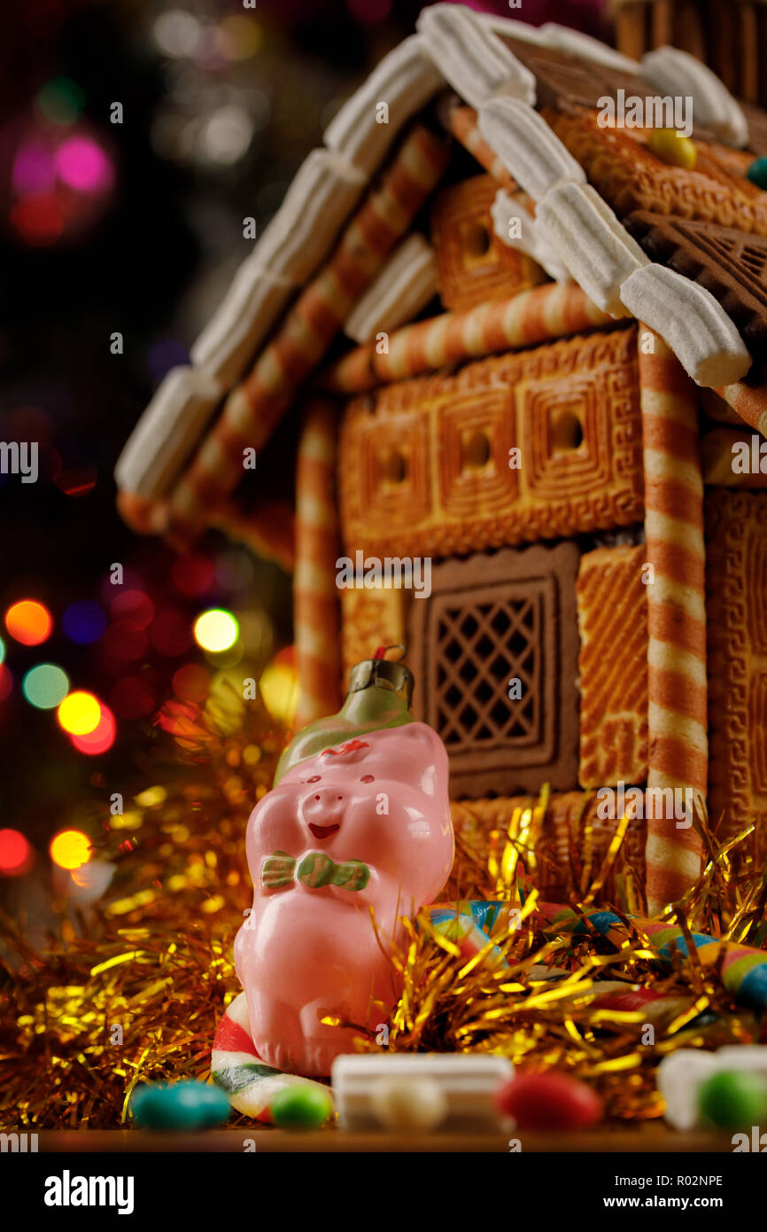 Gingerbread house with sweets and Christmas toy pig. Close-up Stock ...