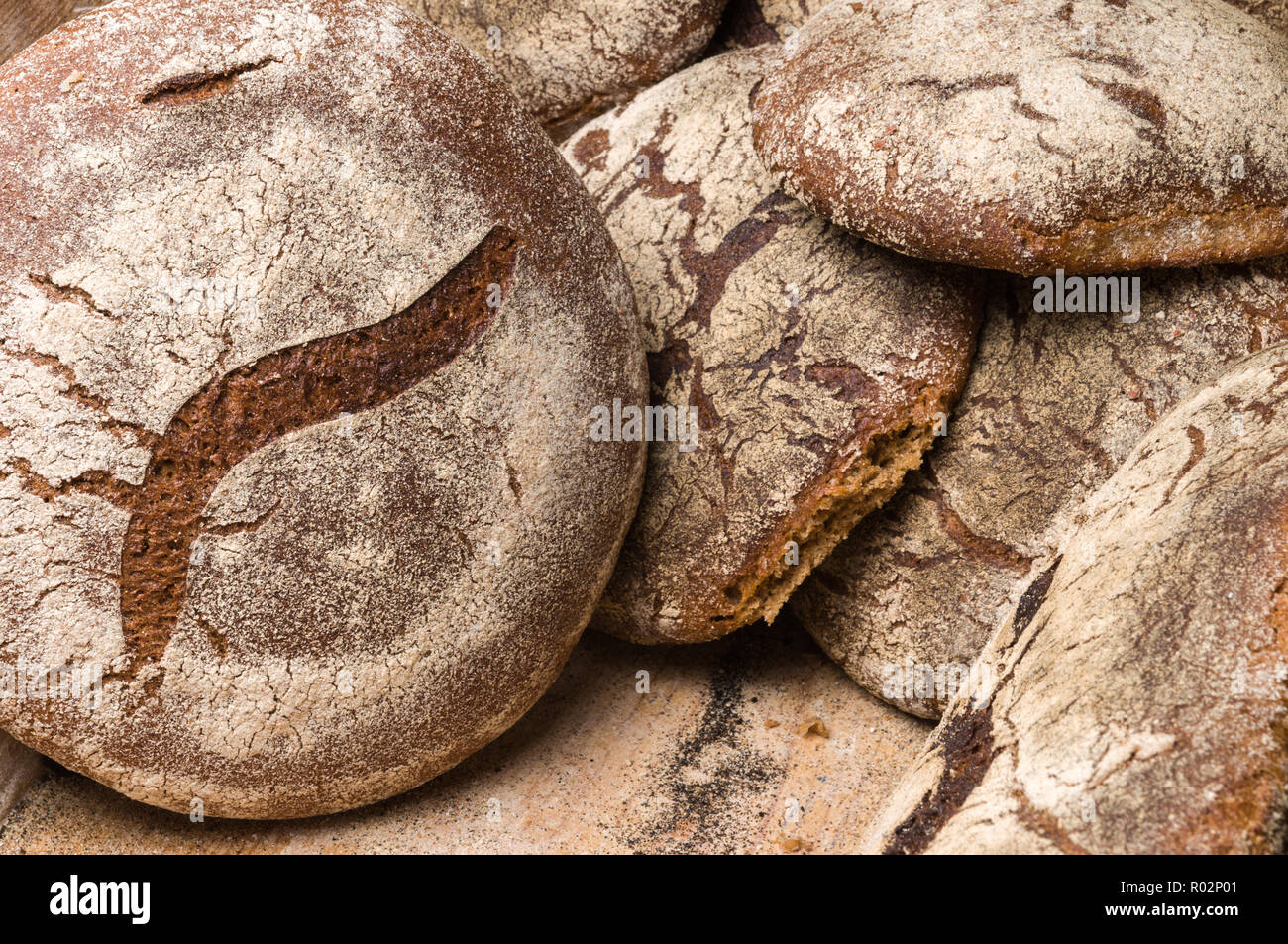 Bakery - gold rustic crusty loaves of bread and buns on black ...