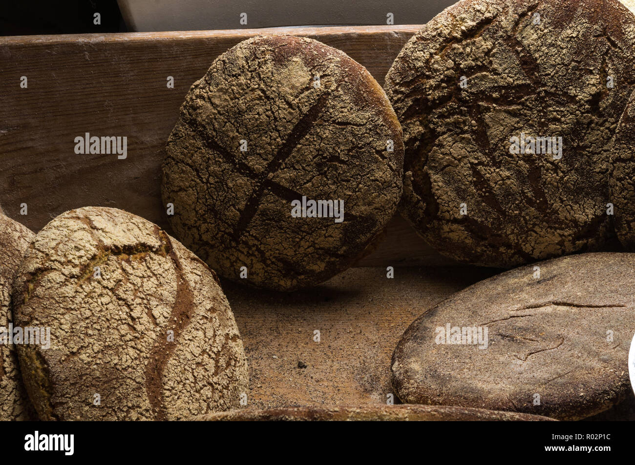 Bakery - gold rustic crusty loaves of bread and buns on black ...