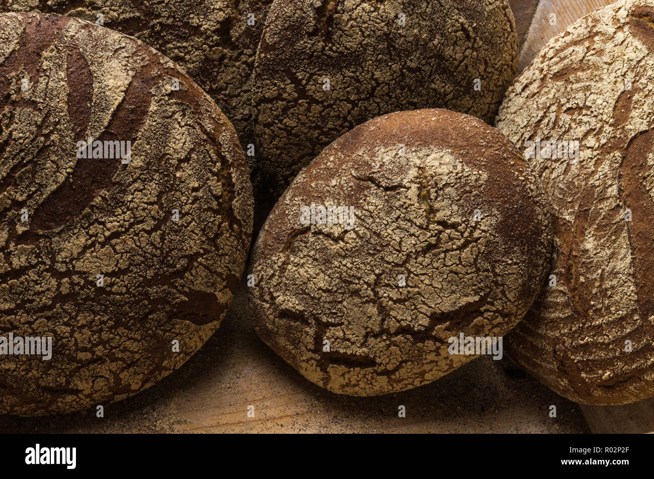 Bakery - gold rustic crusty loaves of bread and buns on black ...