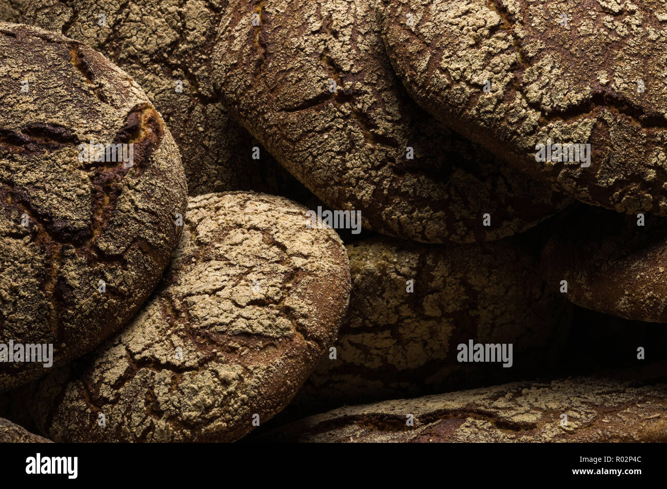 Bakery - gold rustic crusty loaves of bread and buns on black ...