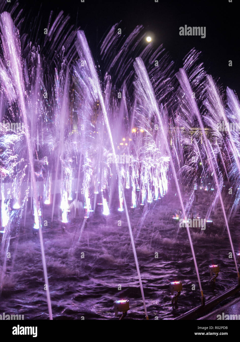 Colored water jets in the fountain at night Stock Photo - Alamy