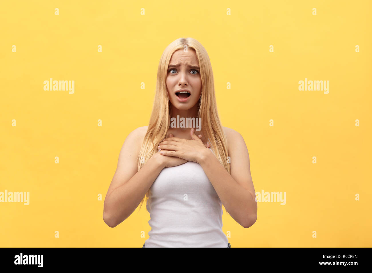 Portrait of a happy excited woman in white shirt with open mouth ...