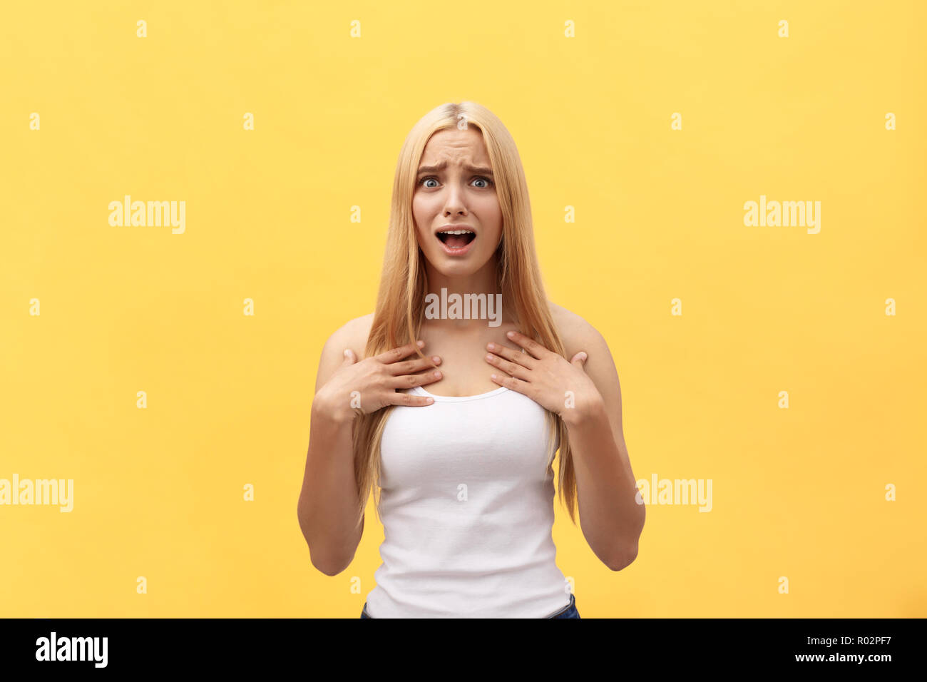 Portrait of a happy excited woman in white shirt with open mouth ...