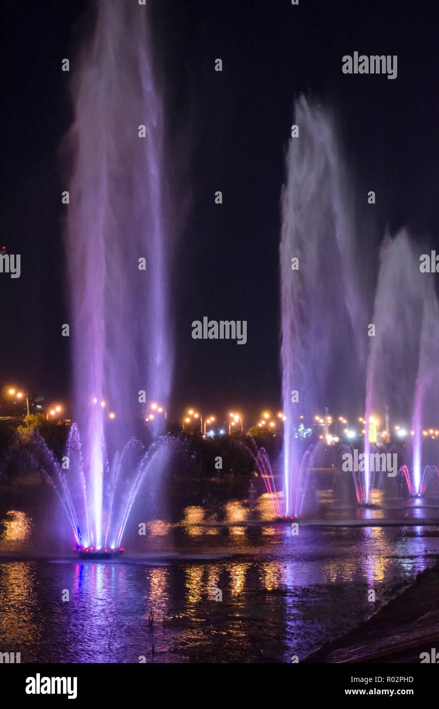 Colored luminous fountains in the middle of the lake at night Stock ...