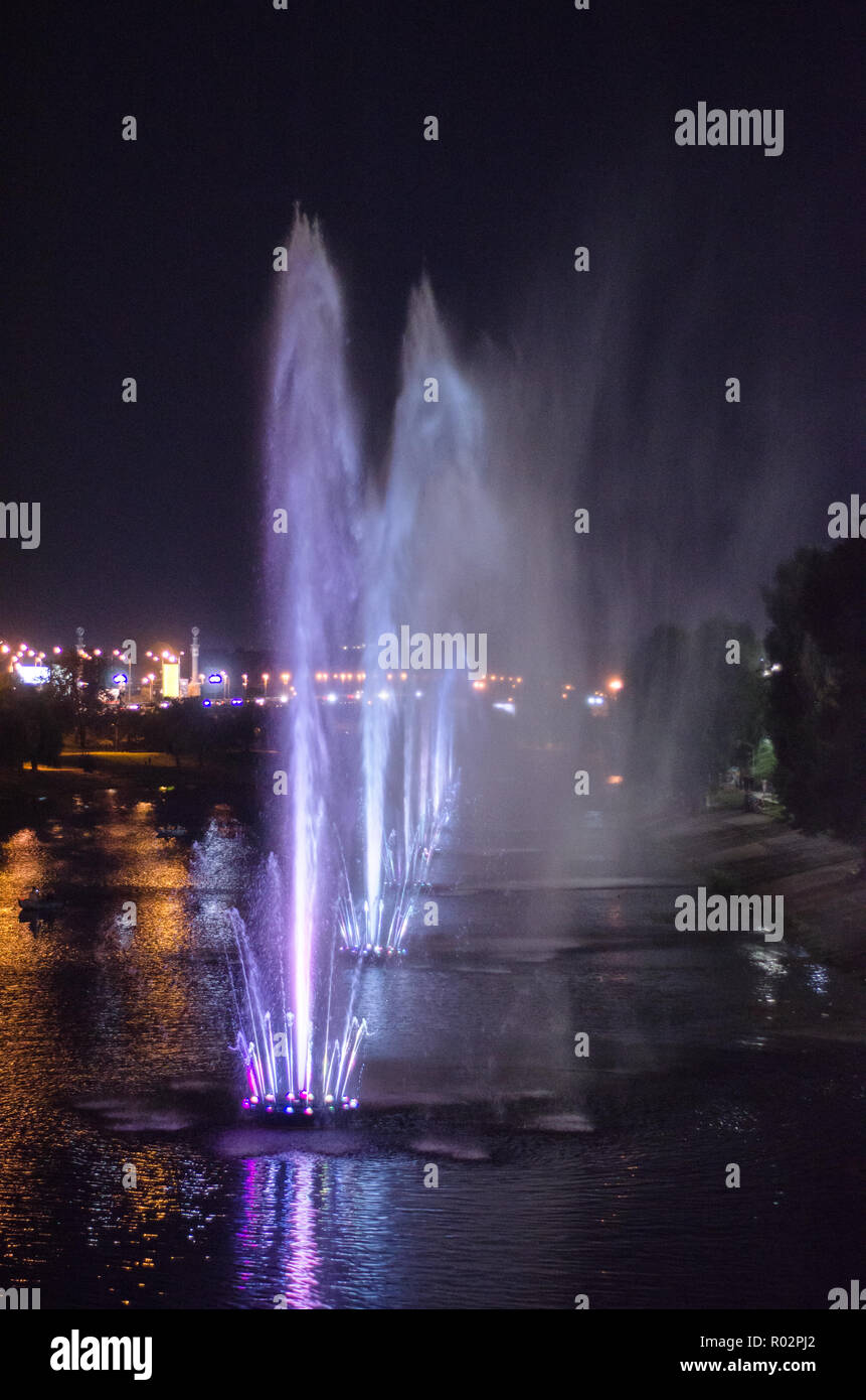 Colored luminous fountains in the middle of the lake at night Stock ...