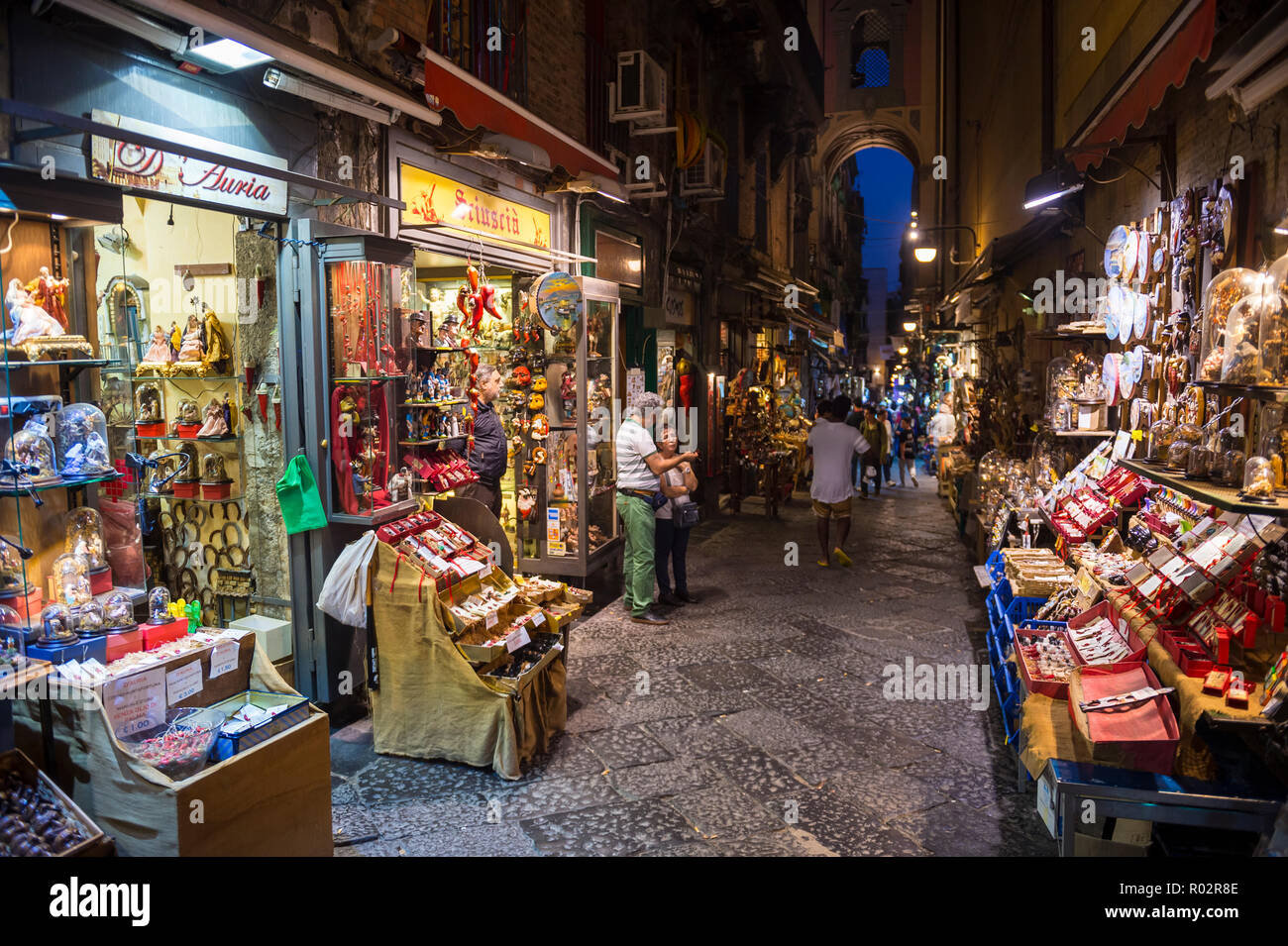 NAPLES, ITALY - CIRCA OCTOBER, 2017: Pedestrians pass displays of ...