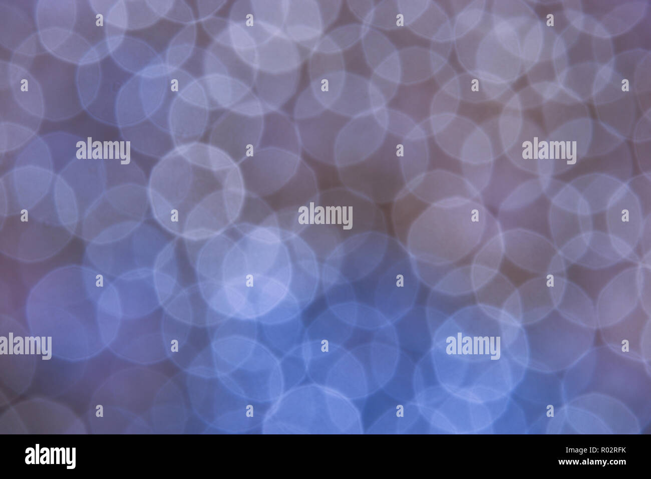Abstract background with many bright blue bokeh rounds closeup ...