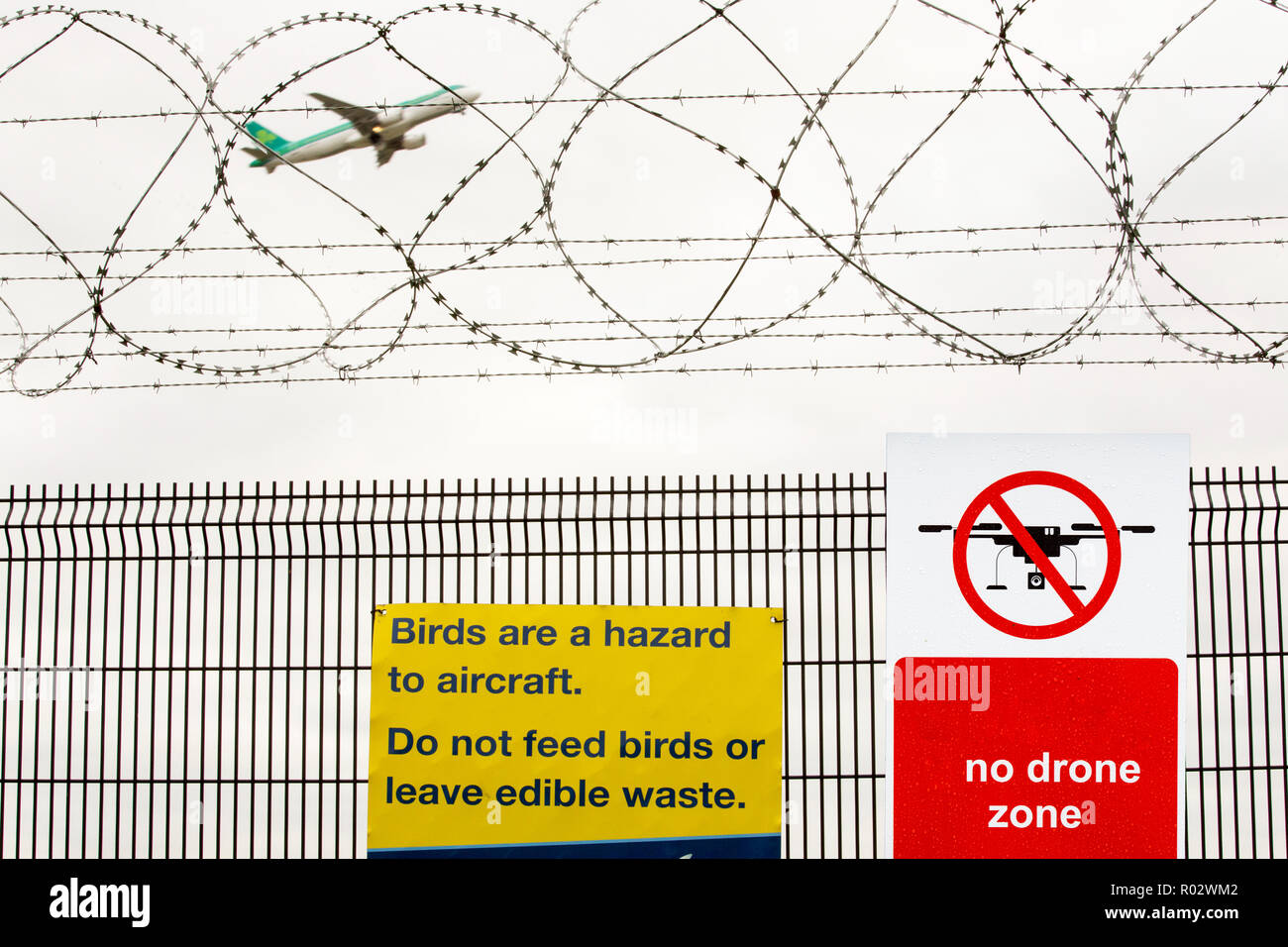 Signs about bird strikes on security fencing at Manchester Airport, UK ...