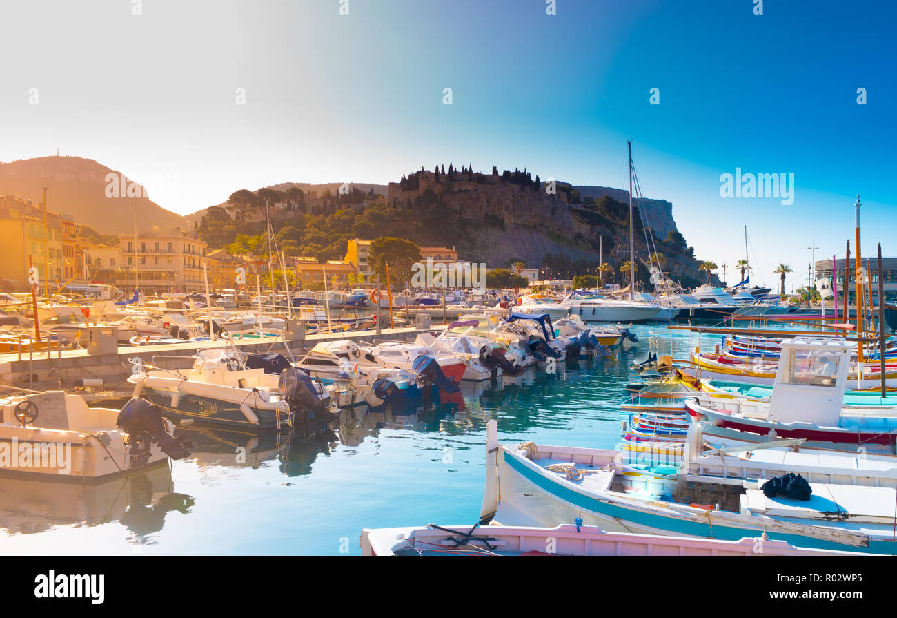 Chateau de Cassis castle on top of hill and close up of boats moored in ...