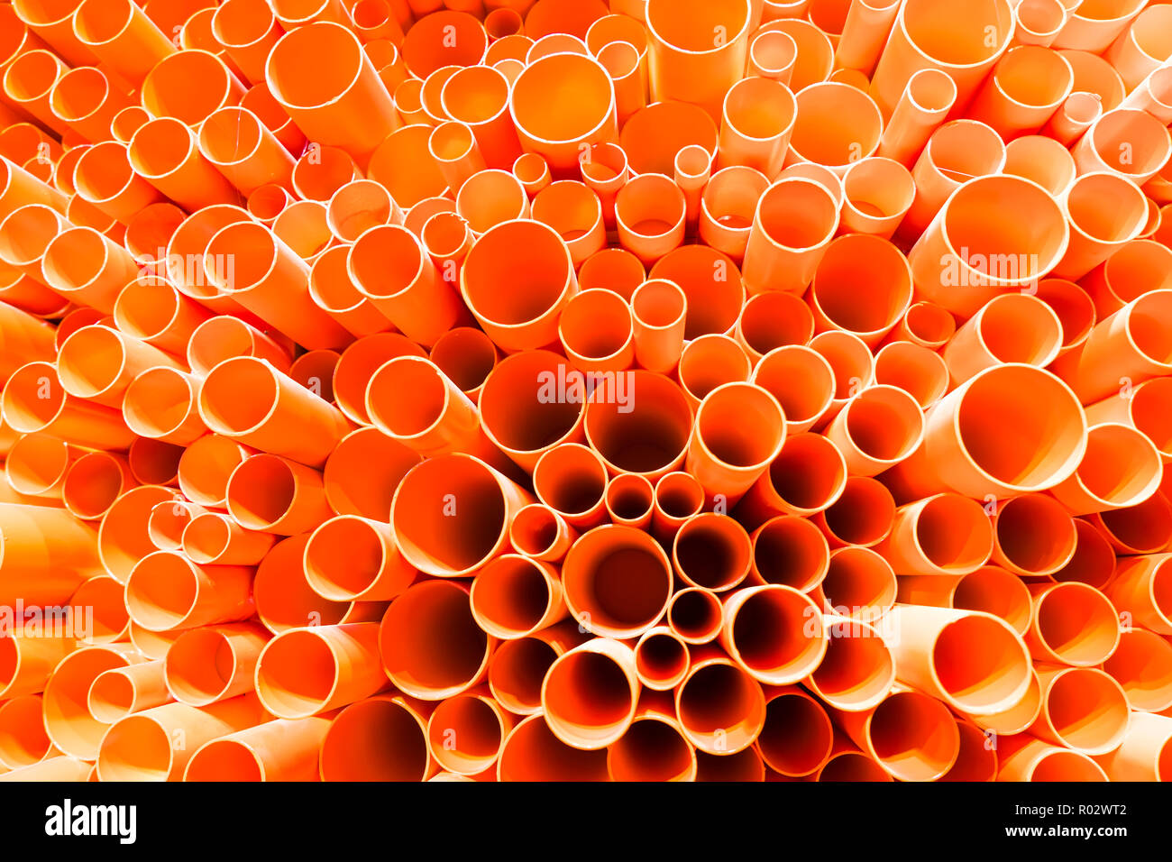 orange PVC pipes stacked in construction site Stock Photo - Alamy