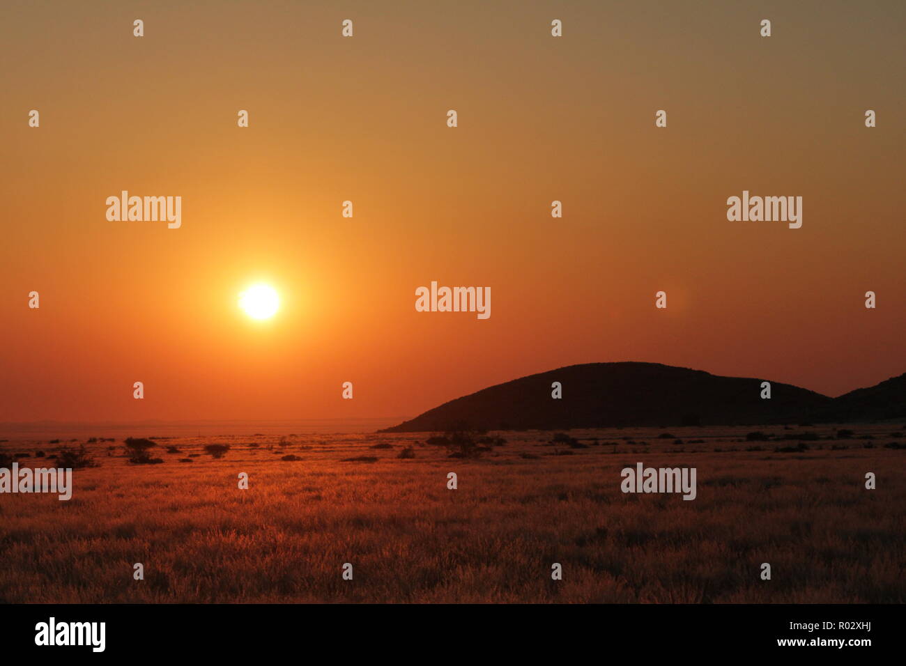 a red orange African desert sunset in Namibia Stock Photo - Alamy