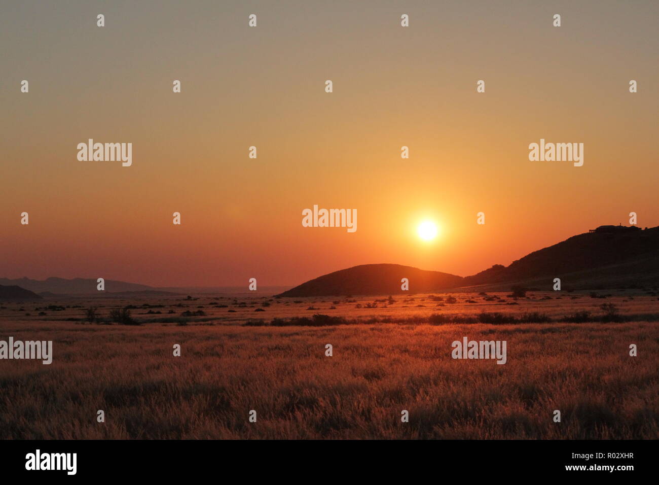 a red orange African desert sunset in Namibia Stock Photo - Alamy