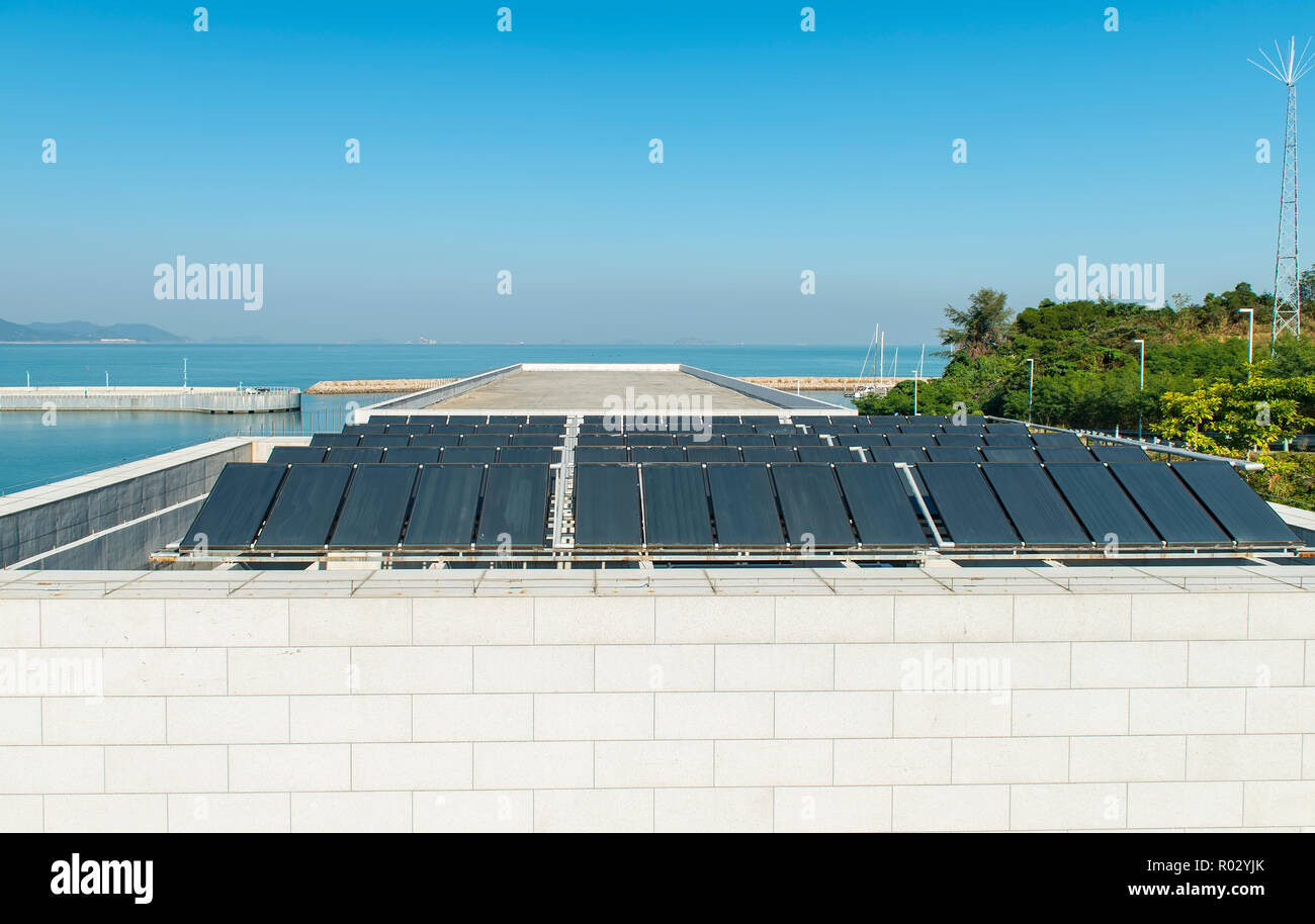Solar water heating panel on a house roof Stock Photo - Alamy