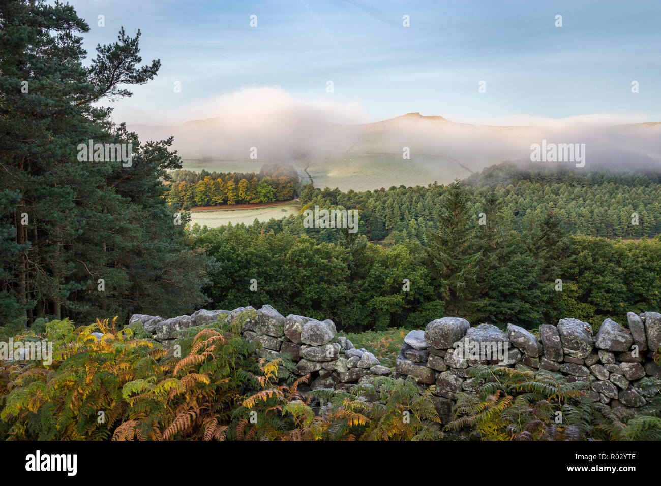 Autumn mist hanging around Crook Hill beside Ladybower reservoir in the ...