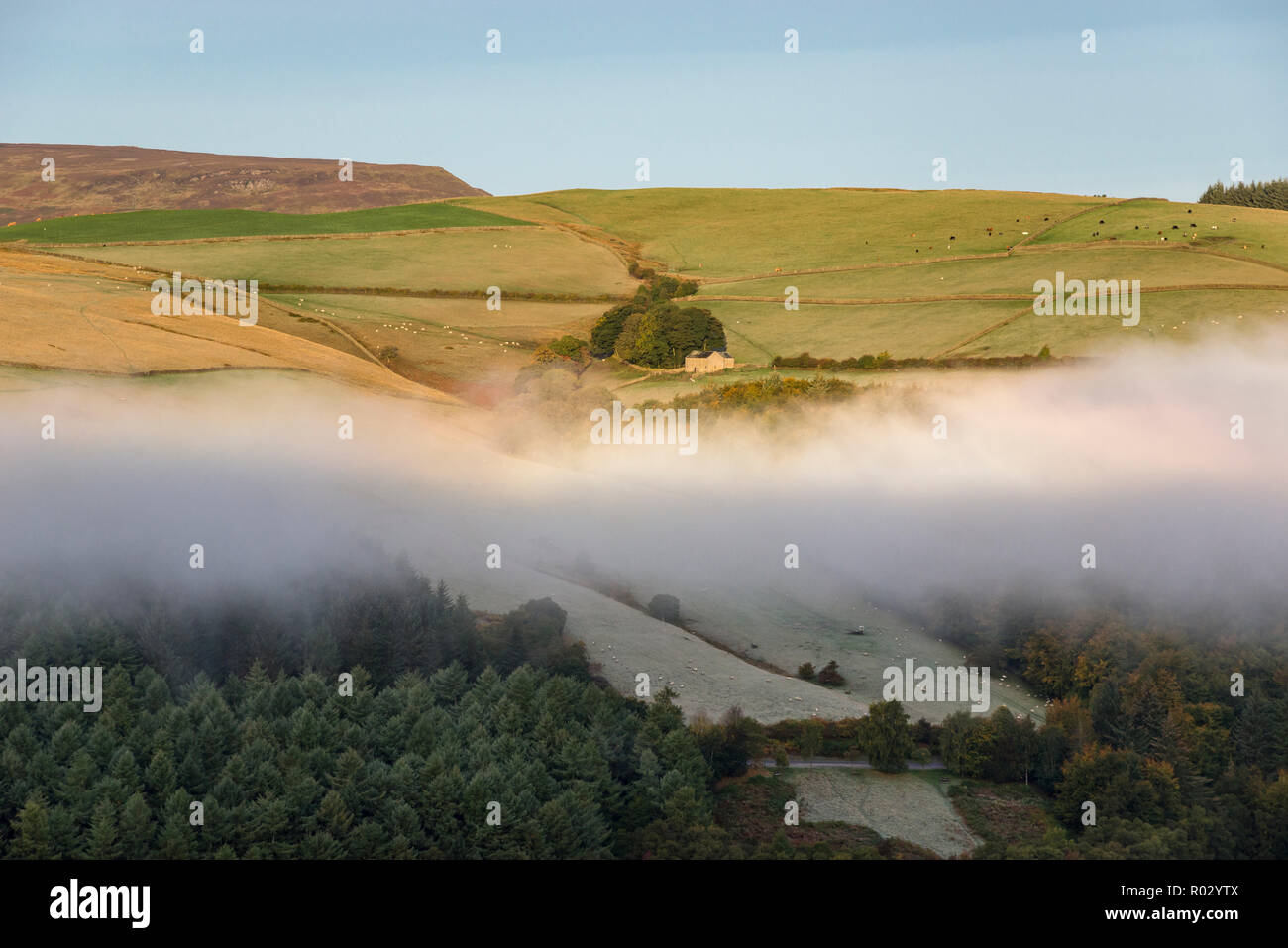Autumn mist hanging around Crook Hill beside Ladybower reservoir in the ...