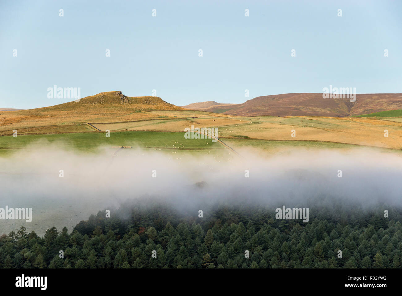 Autumn mist hanging around Crook Hill beside Ladybower reservoir in the ...