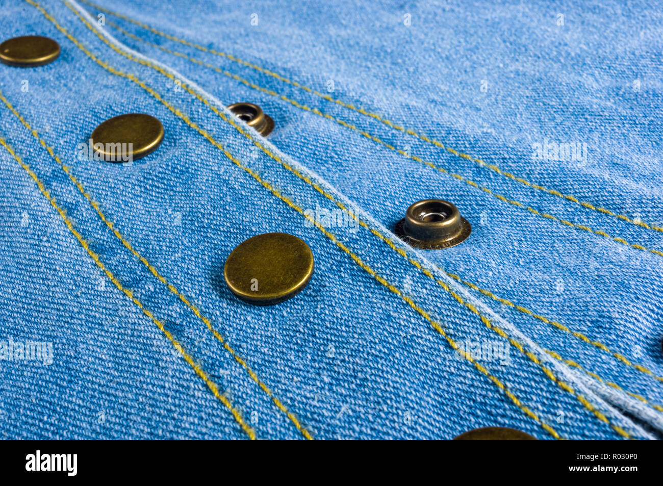 Blue washed faded jeans texture with seams, clasps, buttons and rivets ...