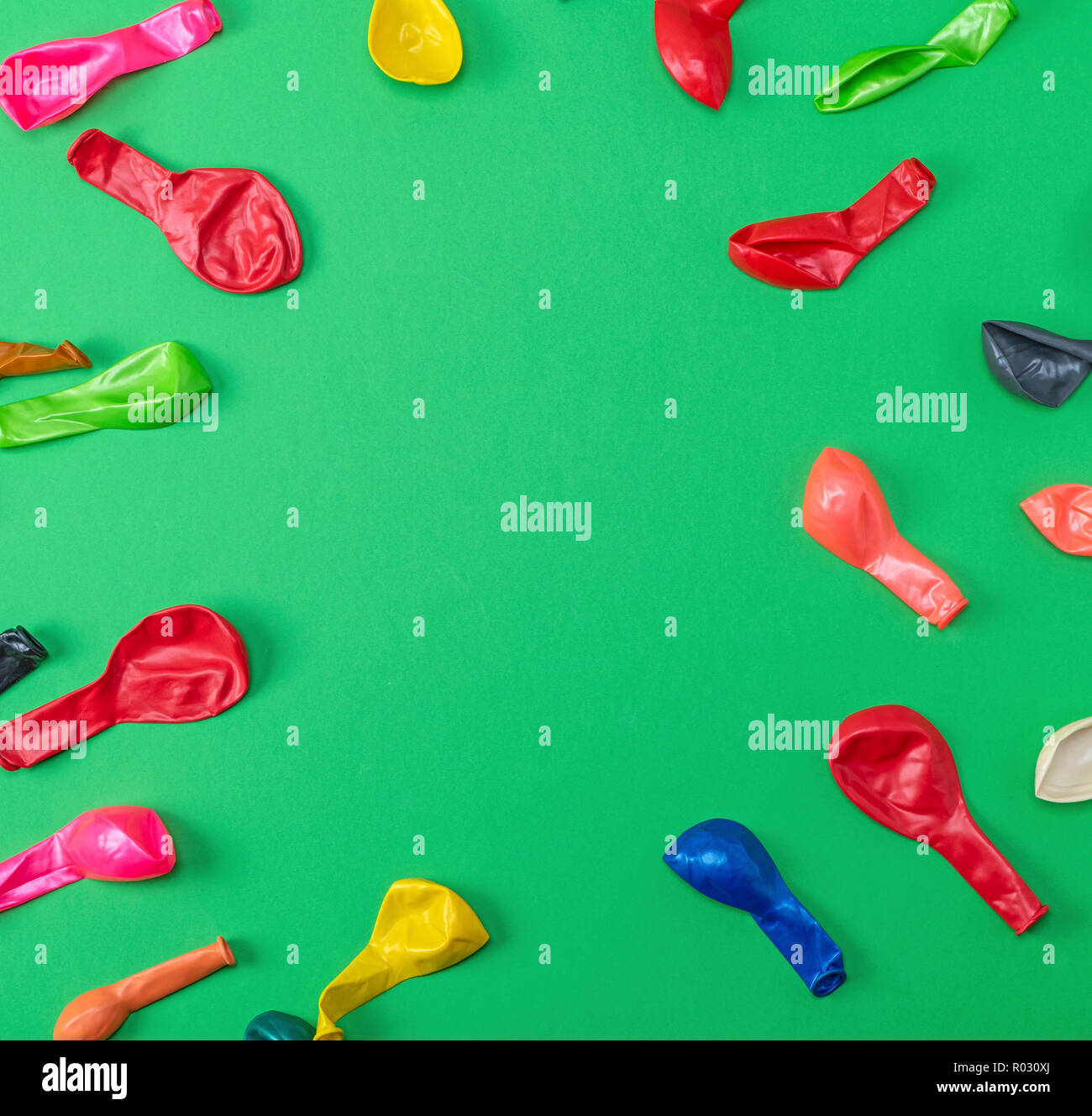 colorful deflated balloons on a green background, copy space Stock ...