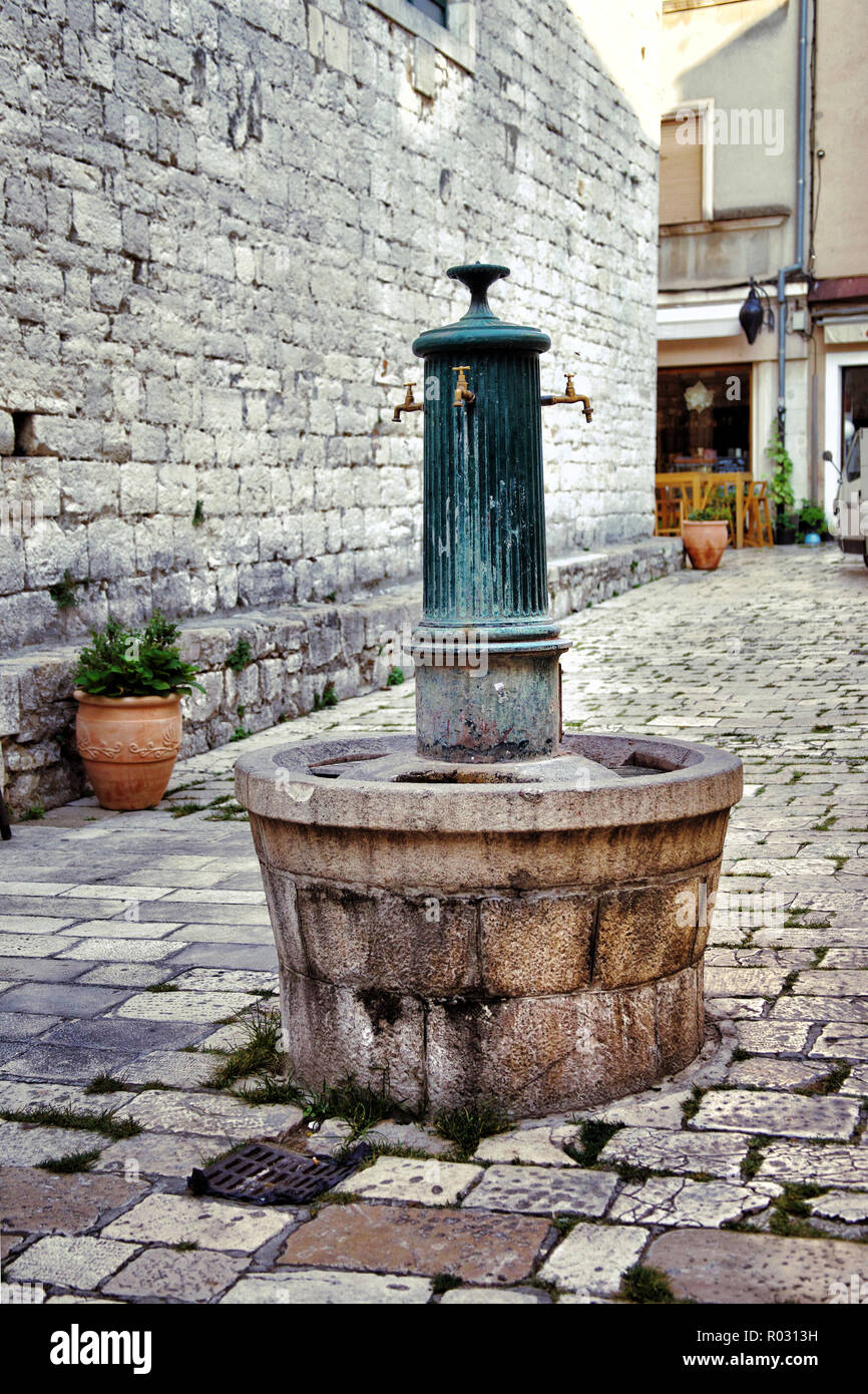 Ancient fountain of drinking water Stock Photo - Alamy