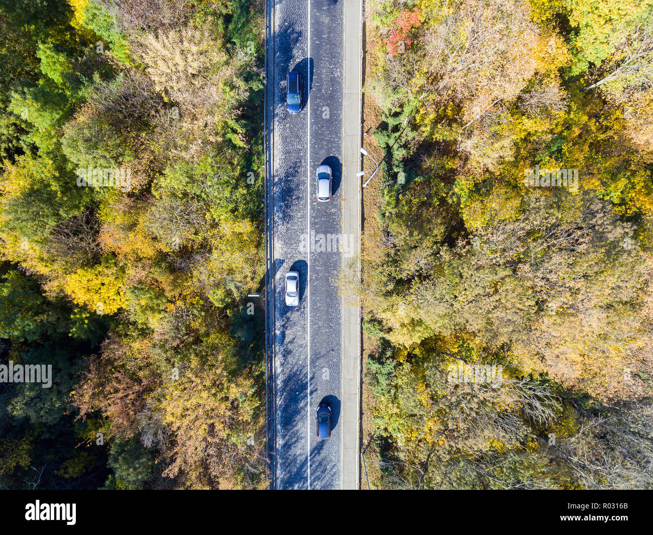 aerial view over car travelling through colorful forest Stock Photo - Alamy