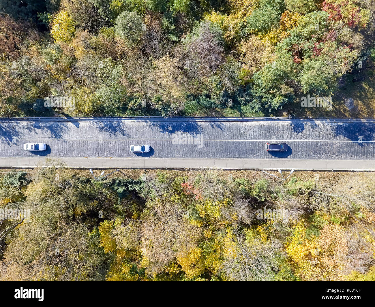 aerial view over car travelling through colorful forest Stock Photo - Alamy