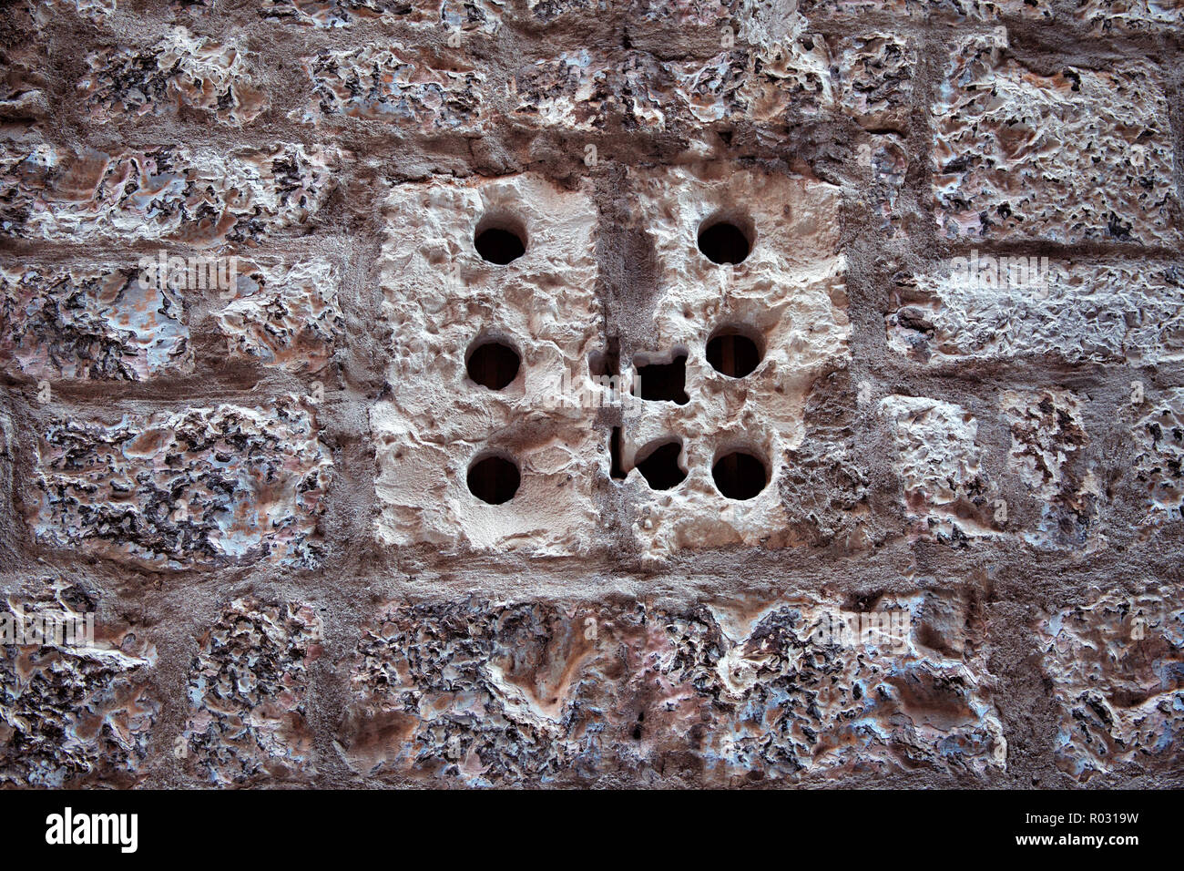 Stone Wall and window with holes in old town Stock Photo - Alamy