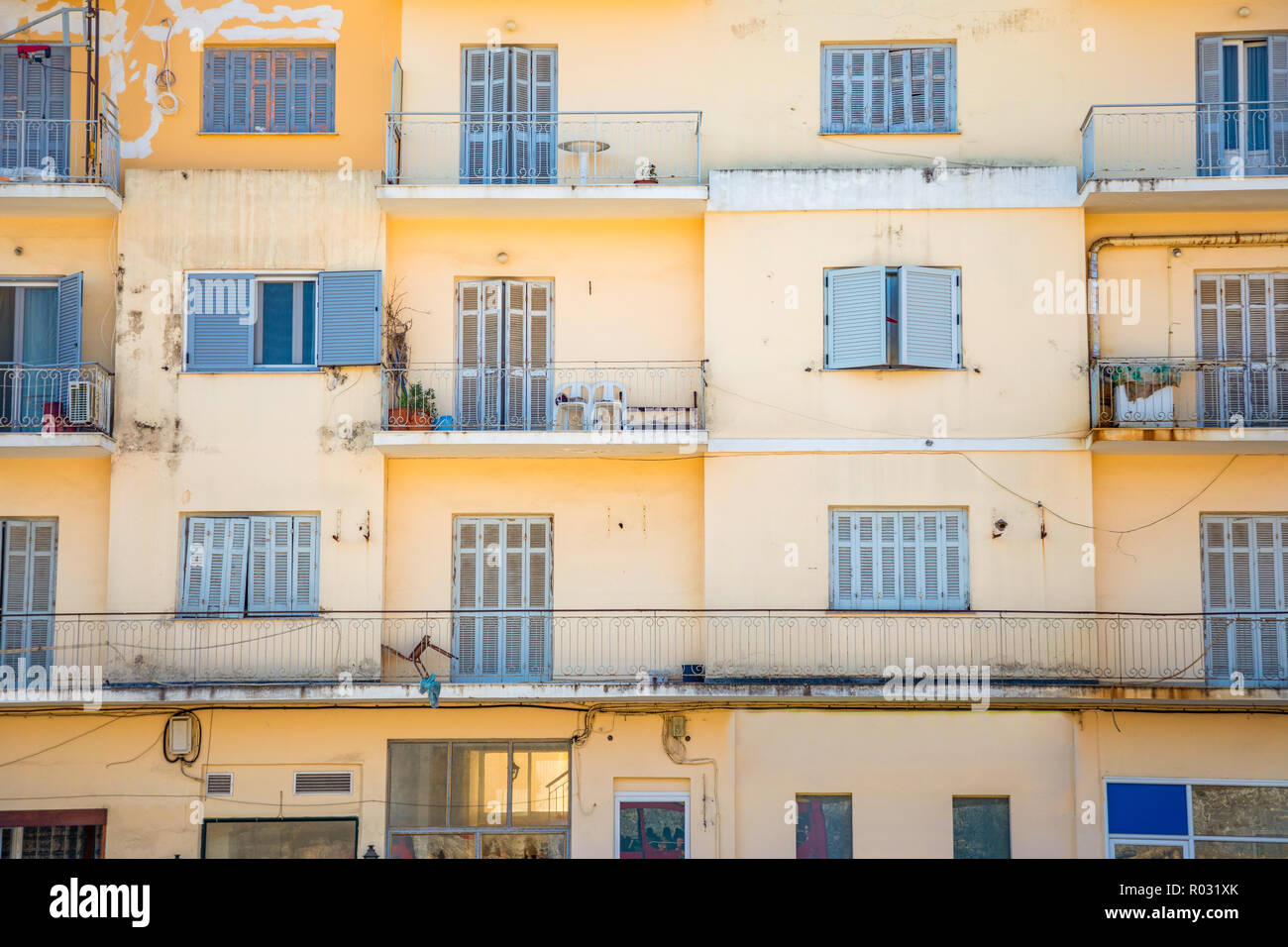 Close-up of facade of old tenement houses with window shutters, Corfu ...