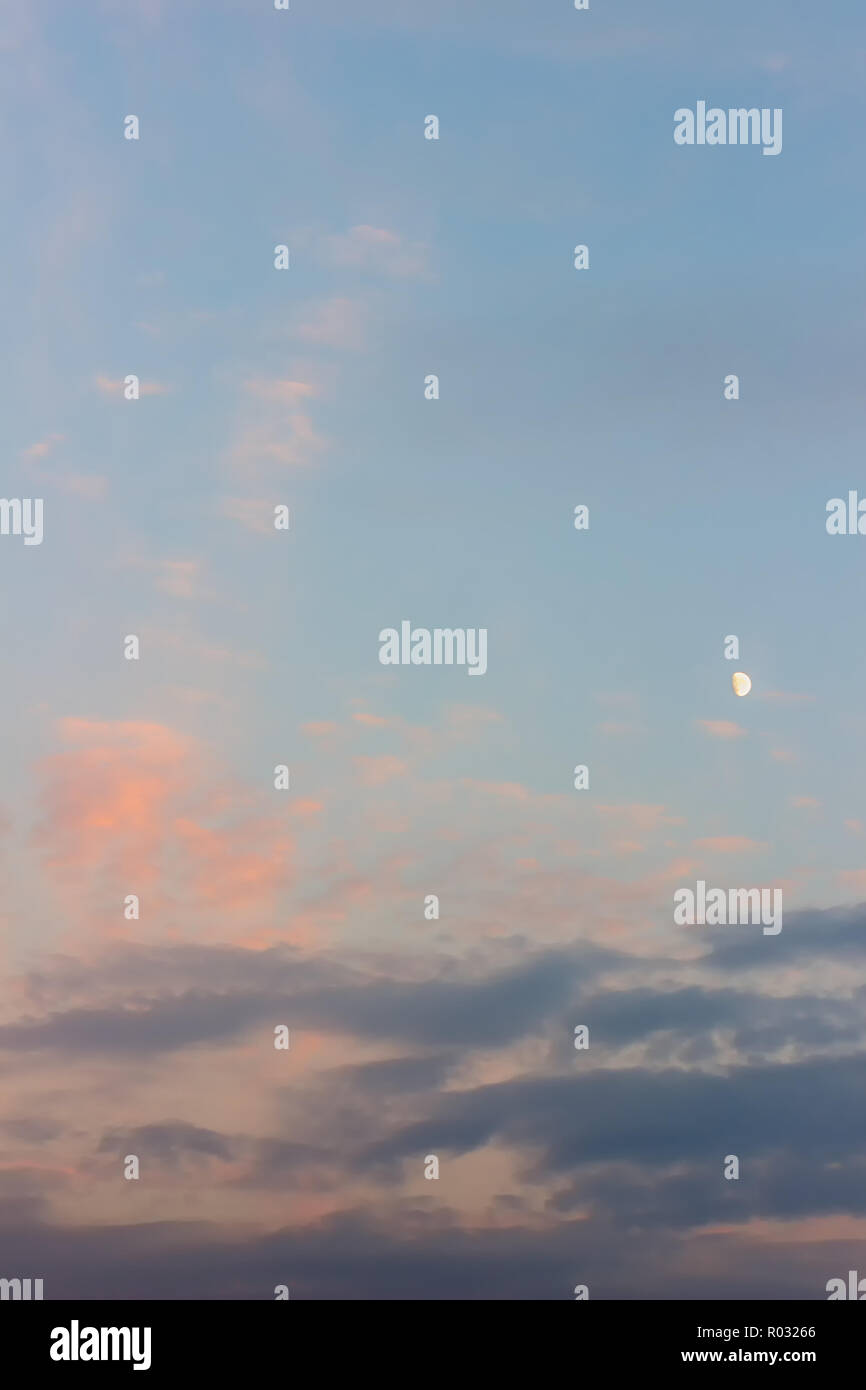 Colorful sunset sky with purple and dark blue clouds and the Moon Stock ...