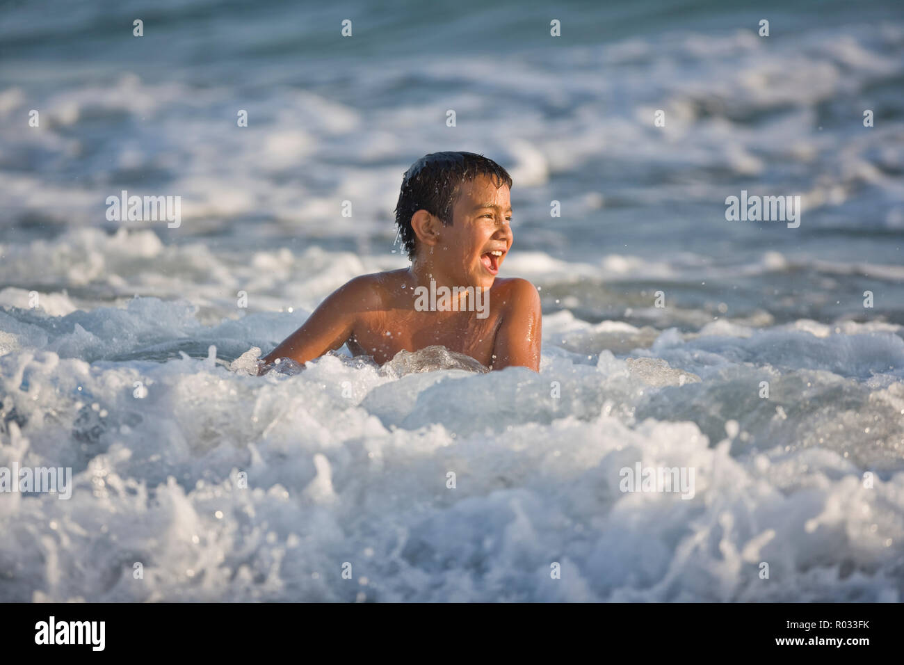 Boy swimming in the ocean Stock Photo - Alamy