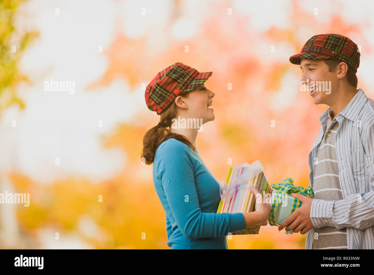 Teenage couple exchanging gifts Stock Photo - Alamy