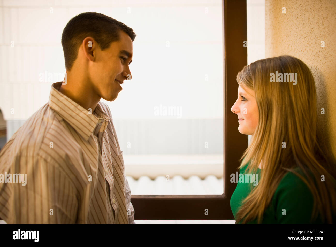 Teenage couple looking into each others eyes Stock Photo - Alamy