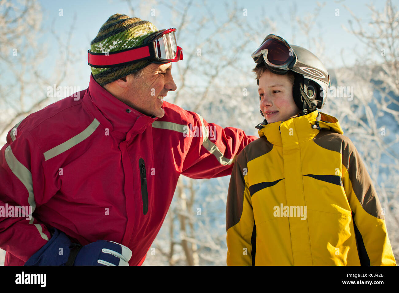 Portrait of a smiling father and son on a ski field Stock Photo - Alamy