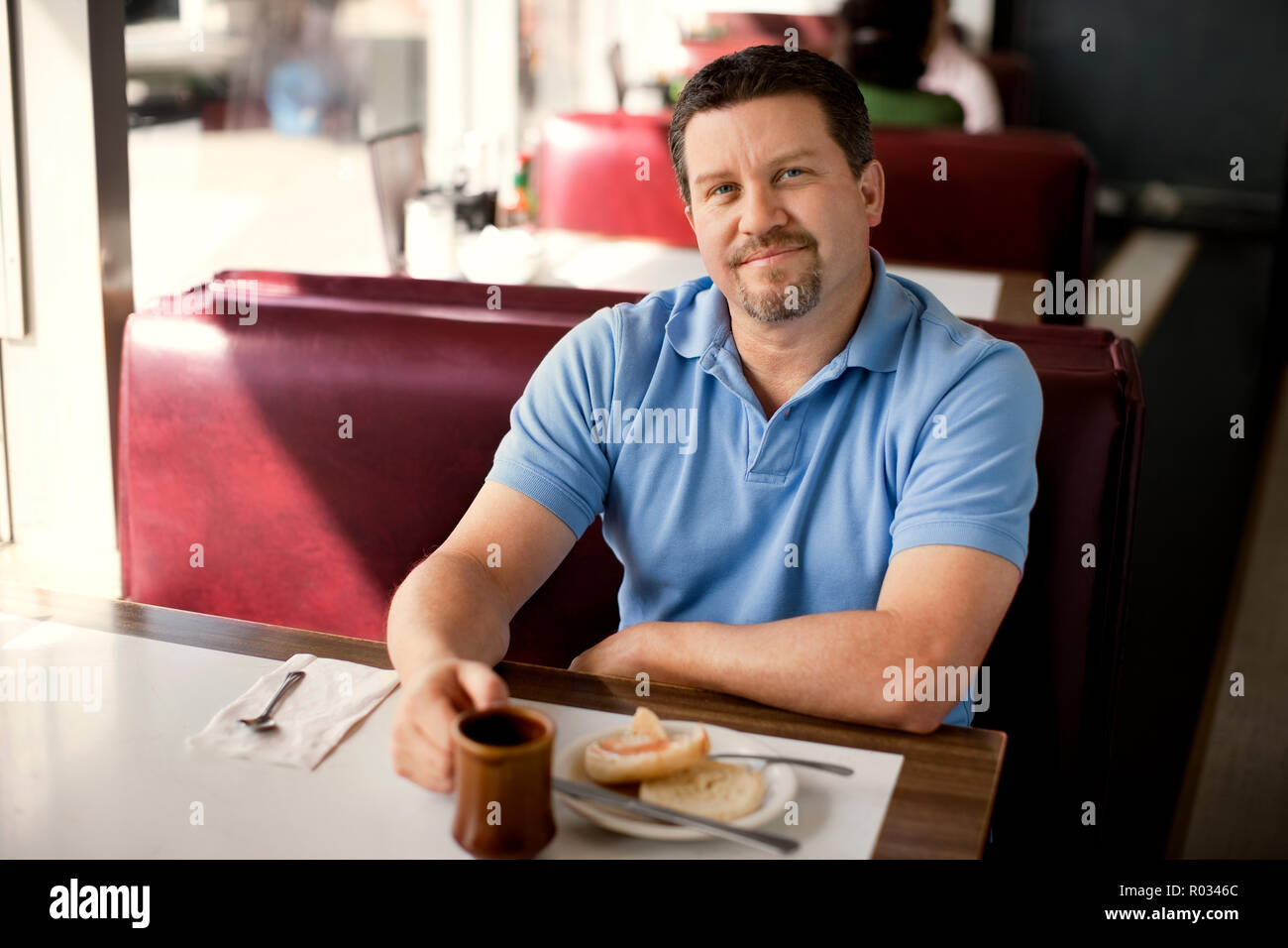 Man sitting diner looking up hi-res stock photography and images - Alamy