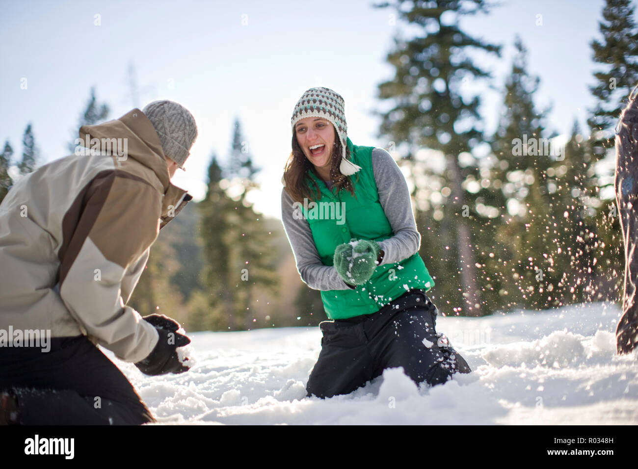 Friends playing in the snow Stock Photo - Alamy