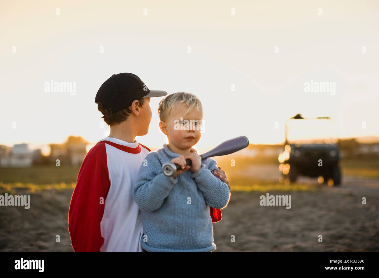 Brothers playing baseball Stock Photo - Alamy