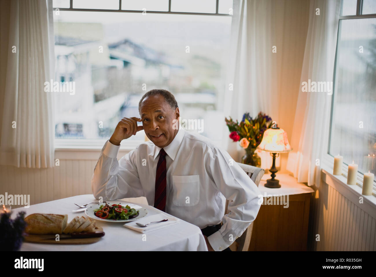 Mature man alone at dinner time Stock Photo - Alamy