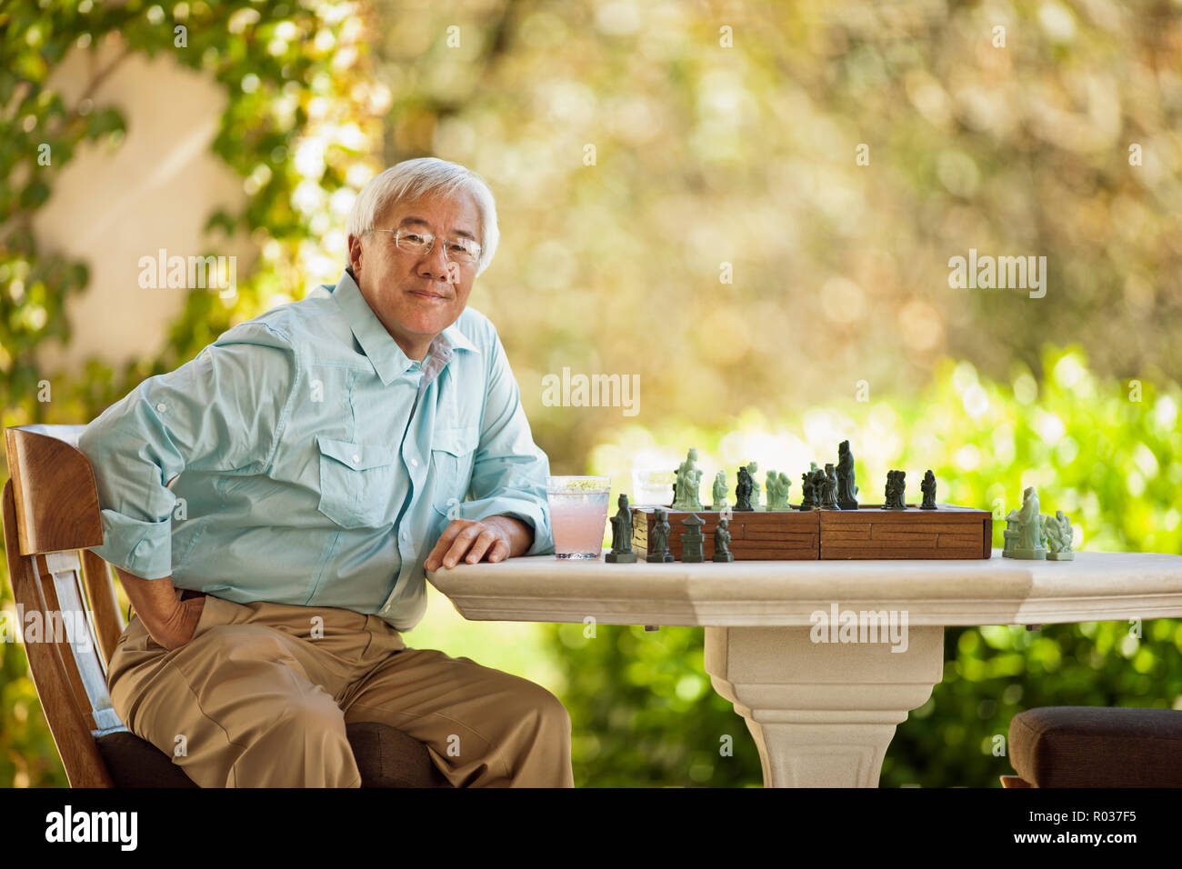 Portrait of a happy man playing chess Stock Photo - Alamy