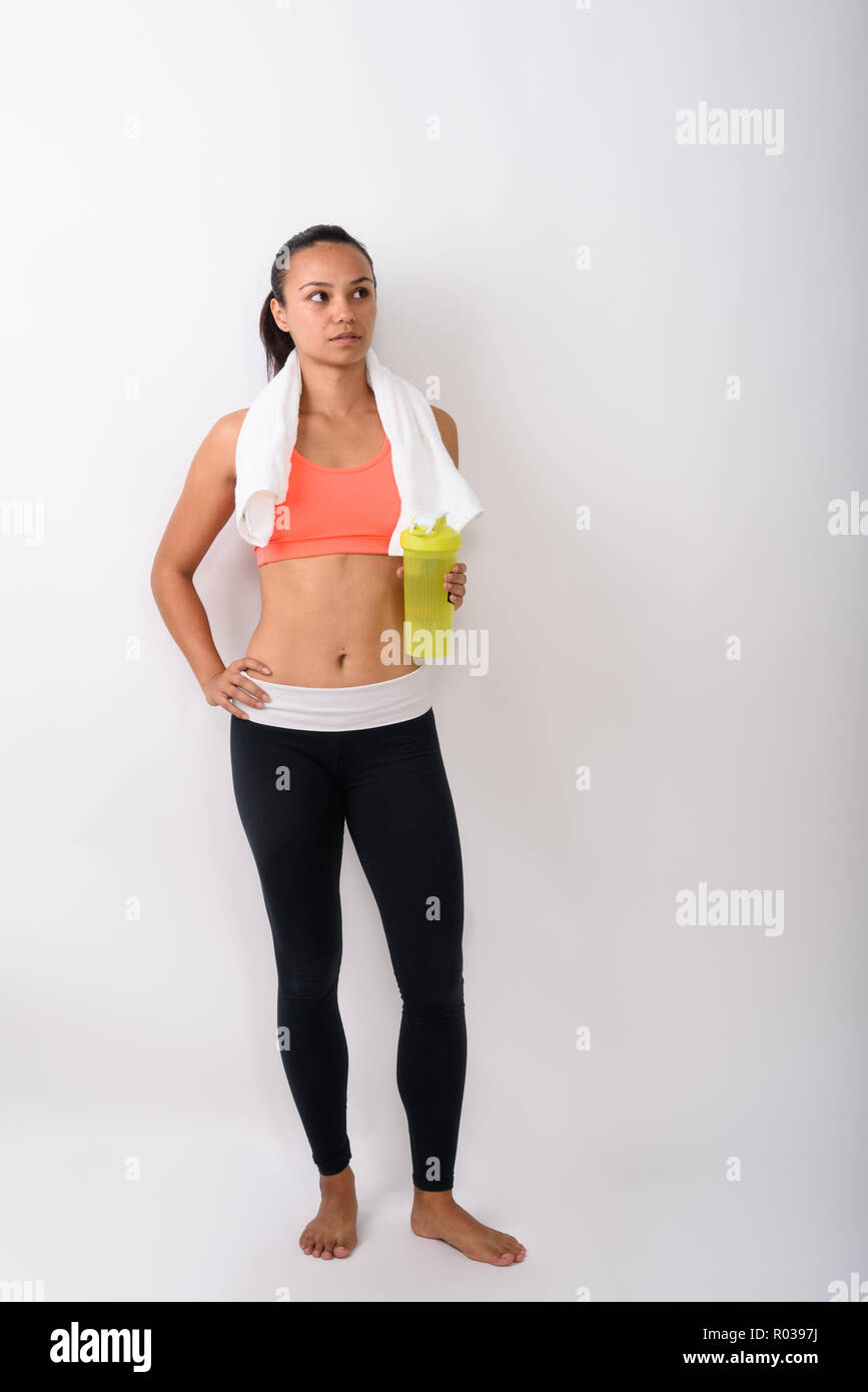 Full body shot of young Asian woman thinking while looking up Stock ...