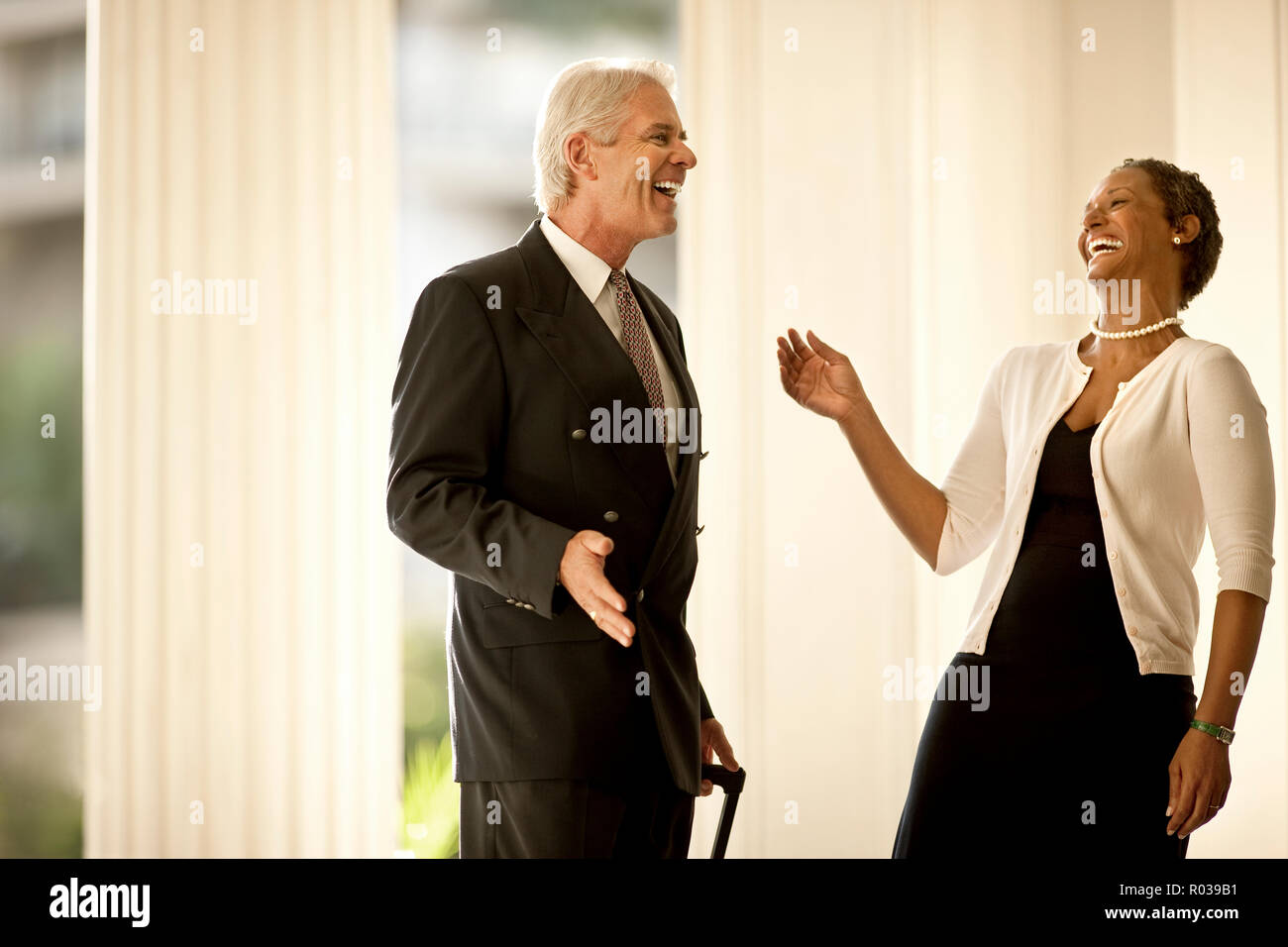 Two business colleagues laughing together Stock Photo - Alamy